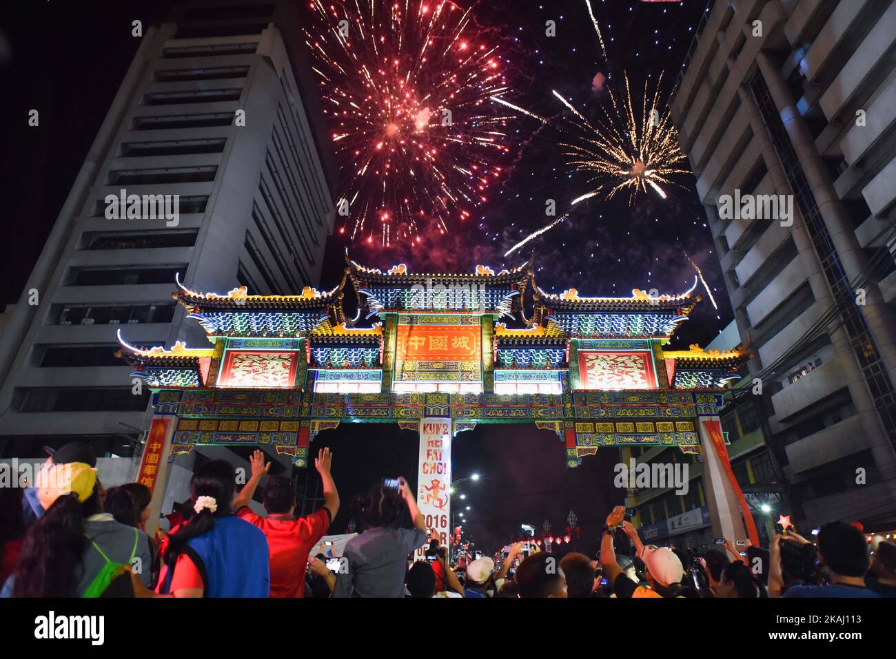 Filipino revelers film the scene with their mobile phones as fireworks ...