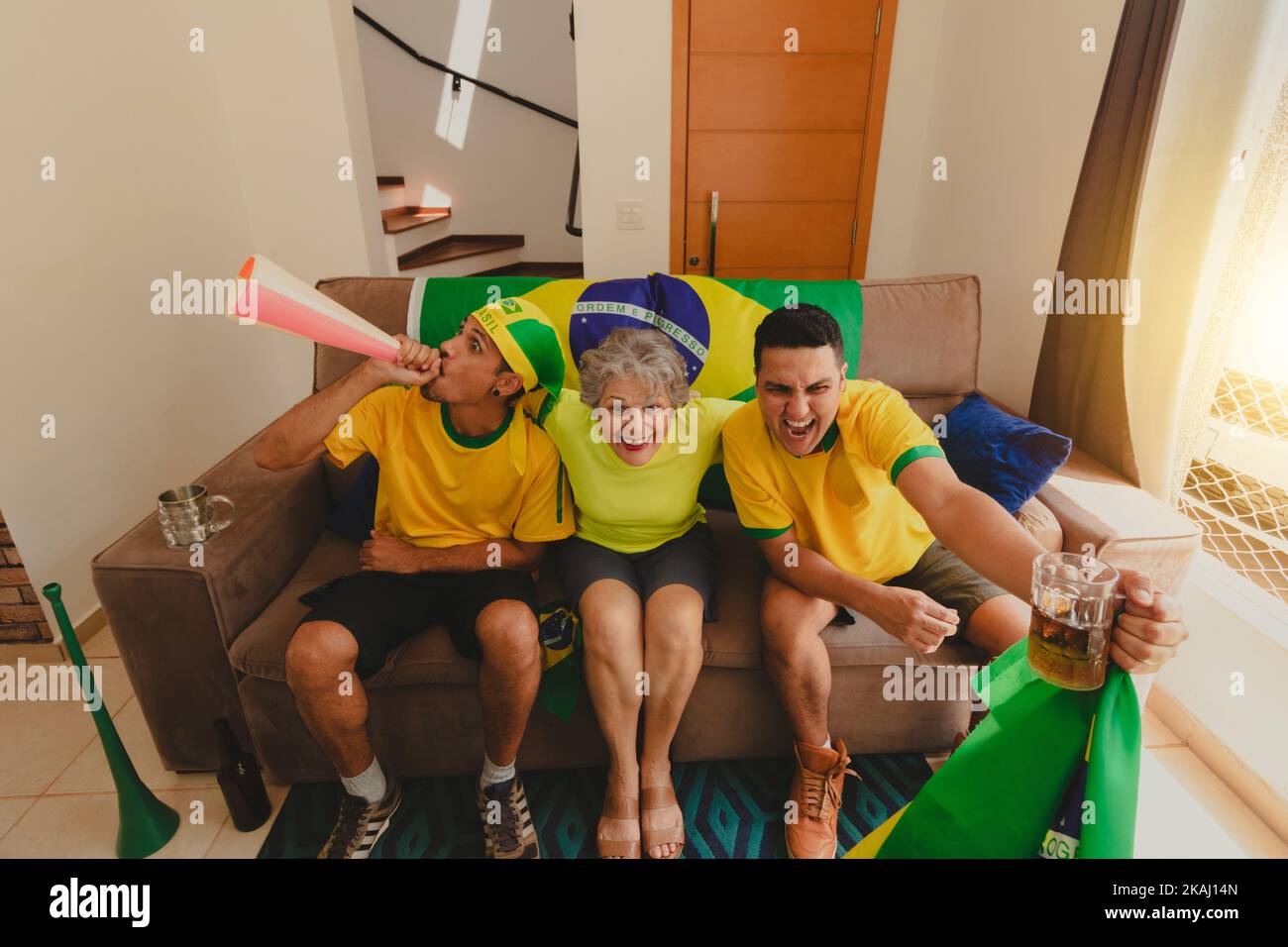 Group of Soccer Fans Celebrating the cup in the living room watching ...