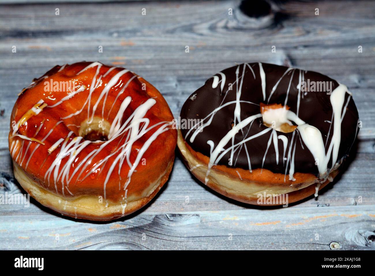 Ring donuts with brown, caramel and white chocolate sauce, A glazed ...