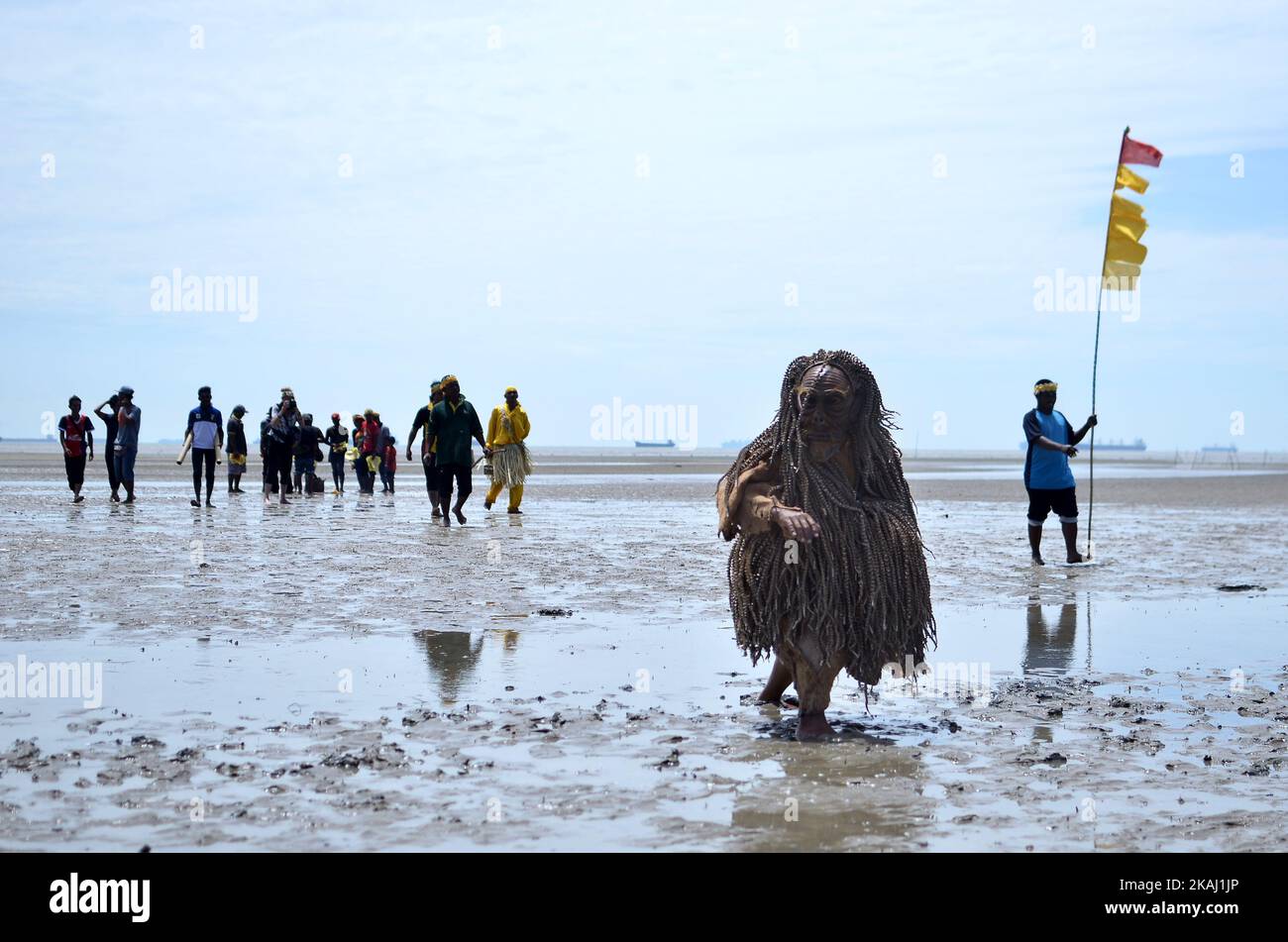 A shaman in wooden mask walks away after finishing the rituals of the ...
