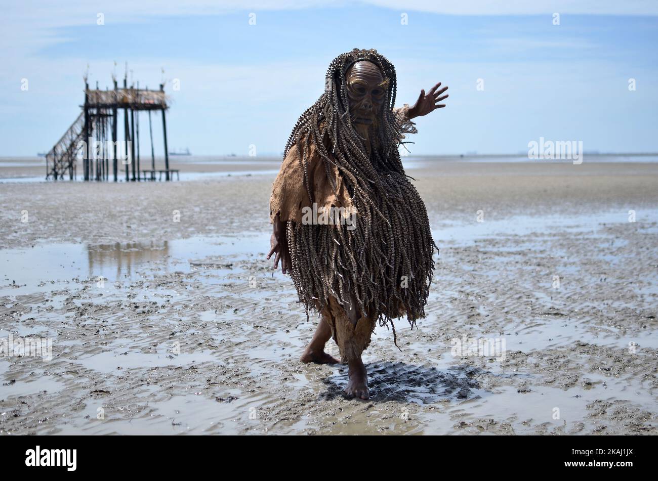 A shaman in wooden mask walks away after finishing the rituals of the ...