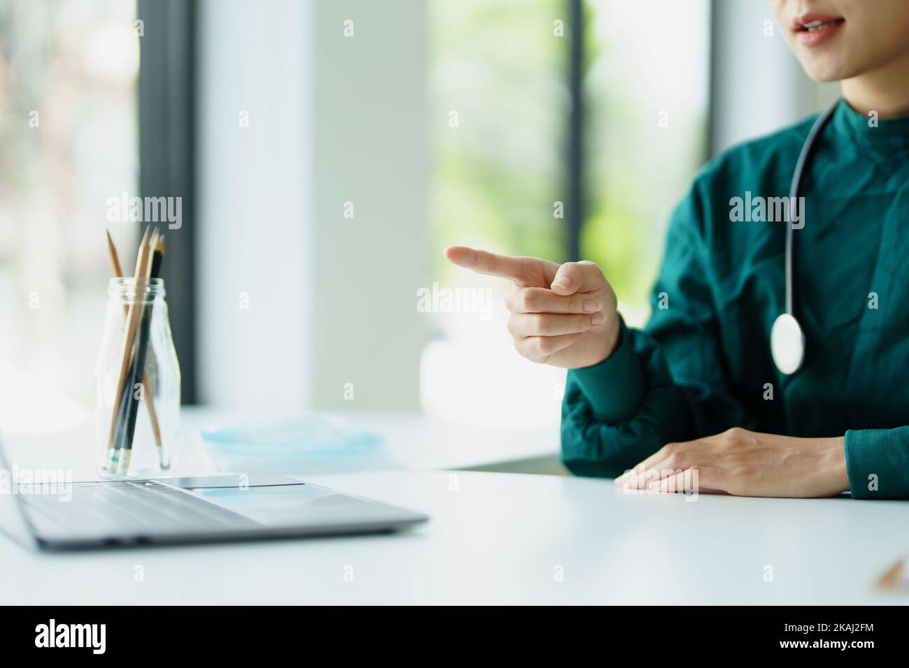 Asian doctor using a computer to look at patient information Stock ...