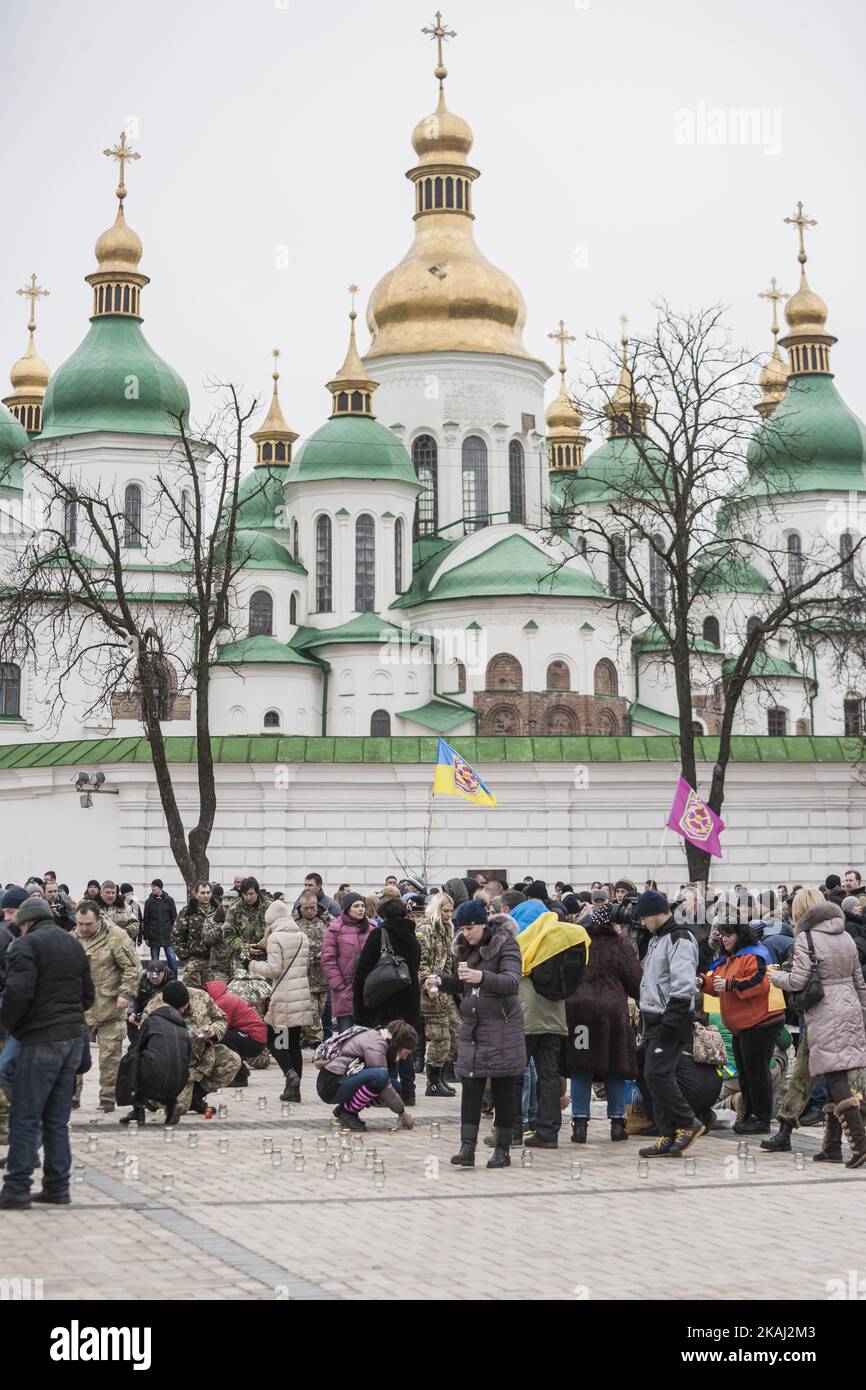People fire candles in remembrance of dead activists in the 2014 riots ...