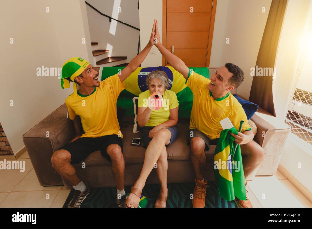 Group of Soccer Fans Celebrating the cup in the living room watching ...