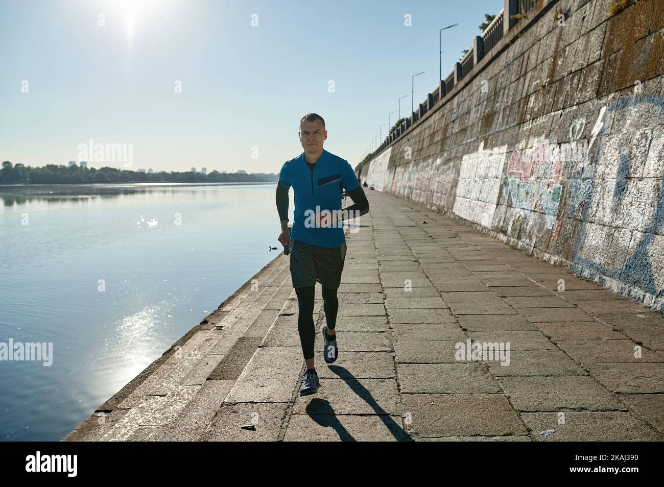 Athletic man running and doing functional workout outdoors Stock Photo ...