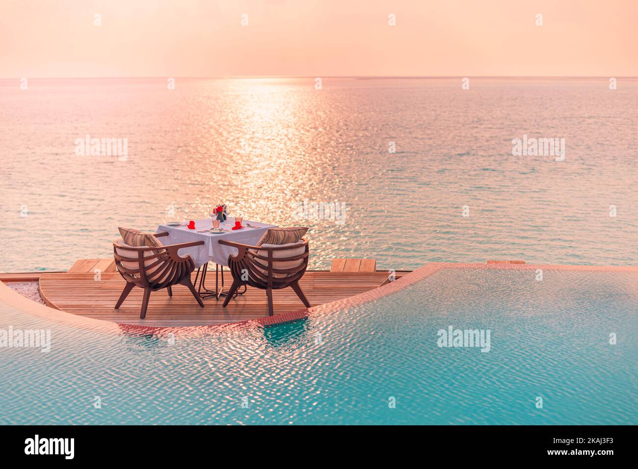 Seascape view under sunset light with dining table with infinity pool ...