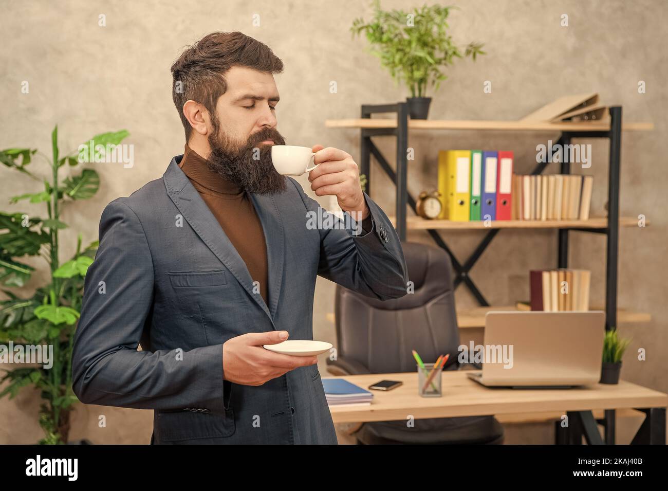 brutal ceo in businesslike suit enjoy morning coffee cup at the office ...