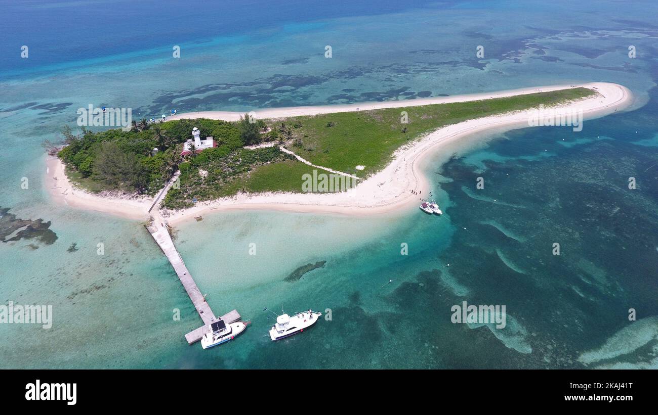An aerial view of Isla de Enmedio with a pier and boats in the blue ...