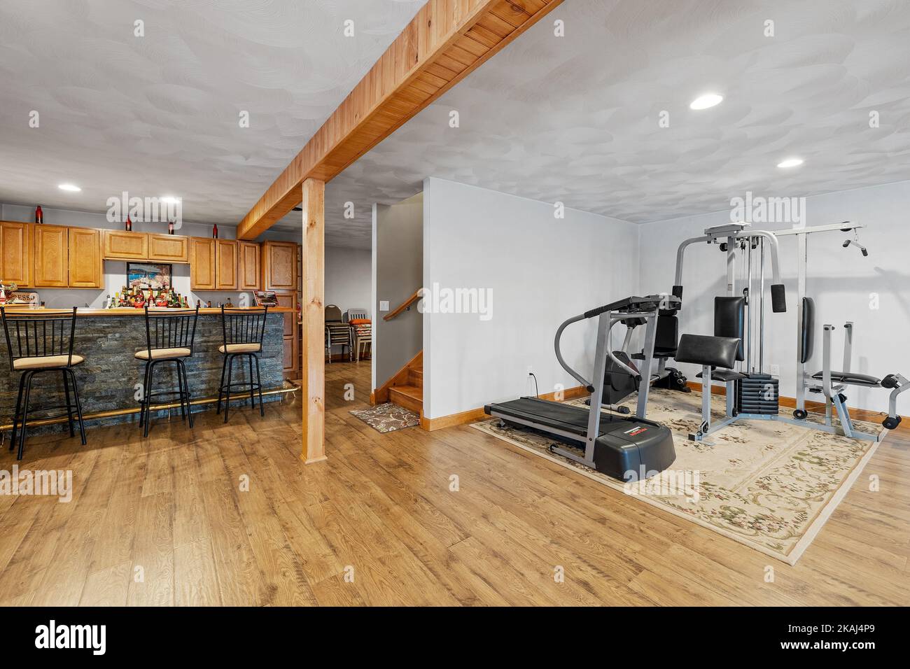 The interior of a rustic house design with a home gym and an open ...