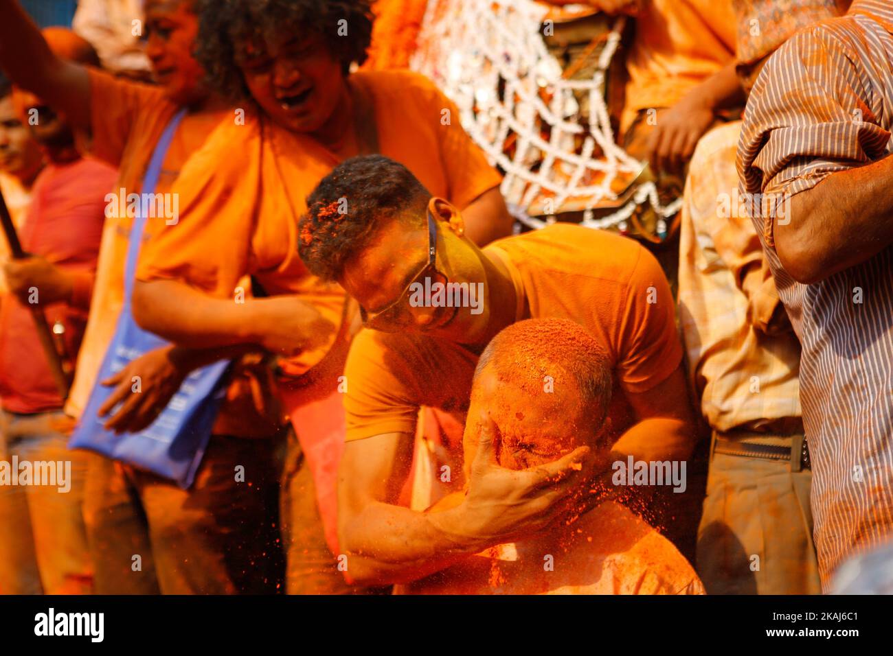 A devotee is smeared with vermillion powder while celebrating the ...