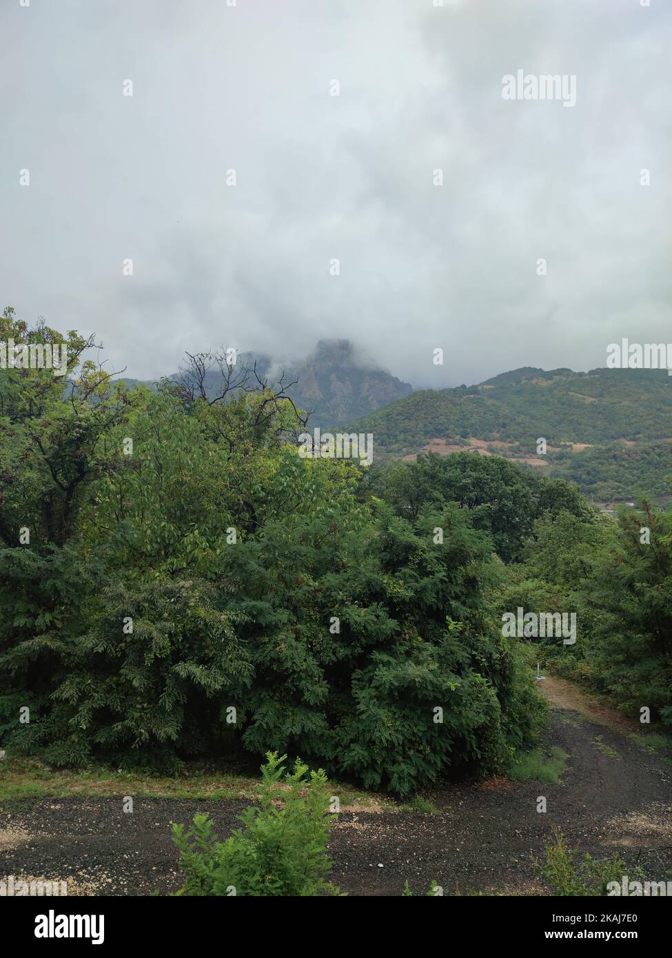A vertical shot of floating clouds over the inactive volcano in the ...