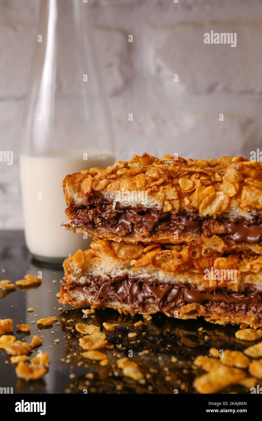 A crunchy cookie with the chocolate kernel, vertical Stock Photo - Alamy