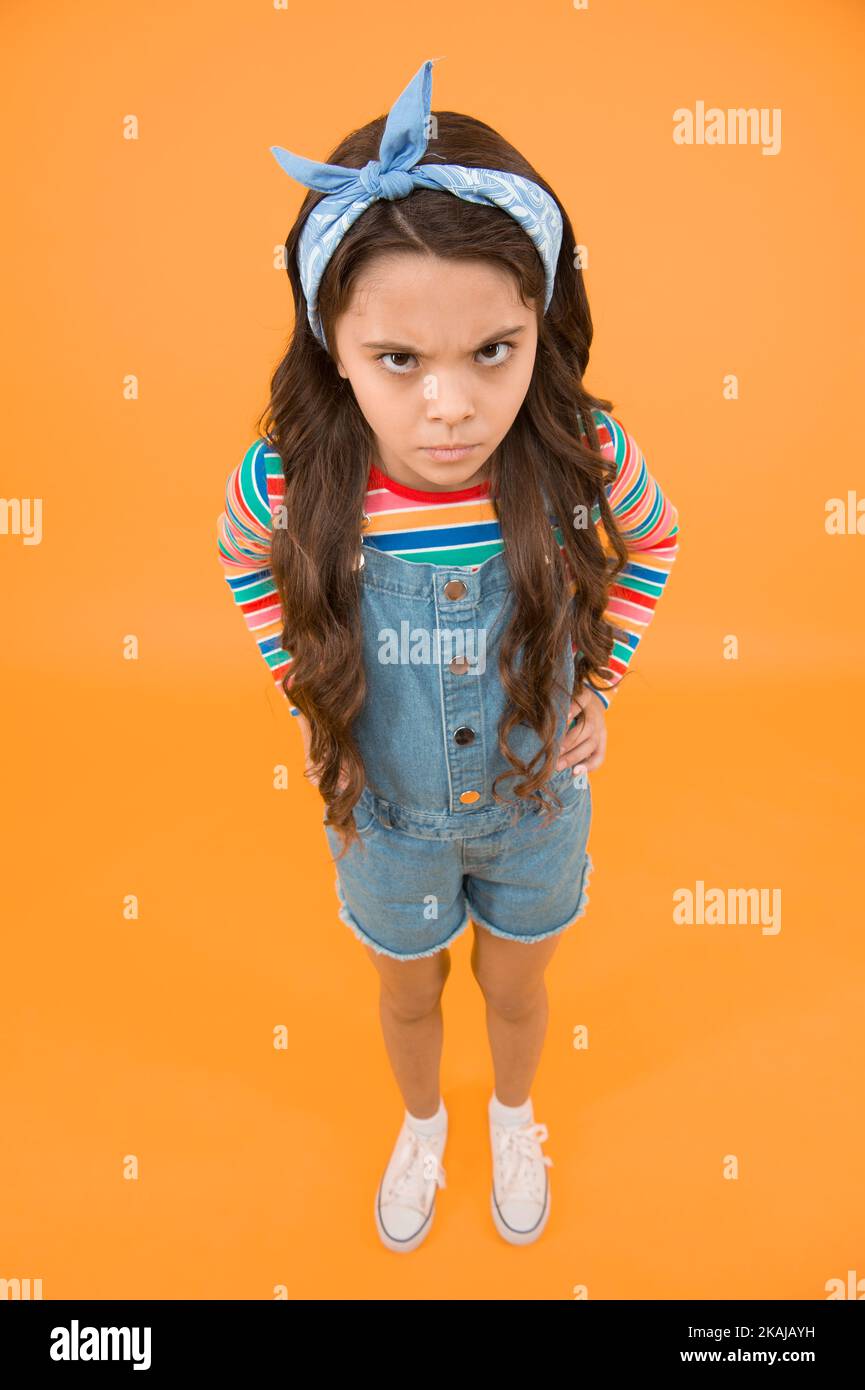 hipster child in bad mood. small girl yellow background. female ...