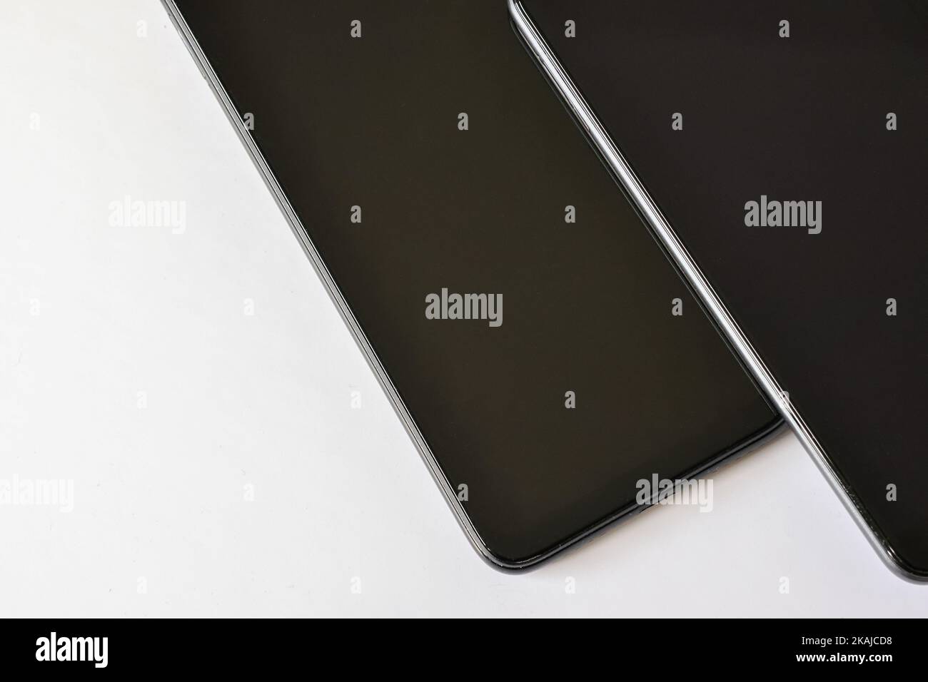 The top view of black smartphones over the white surface Stock Photo ...