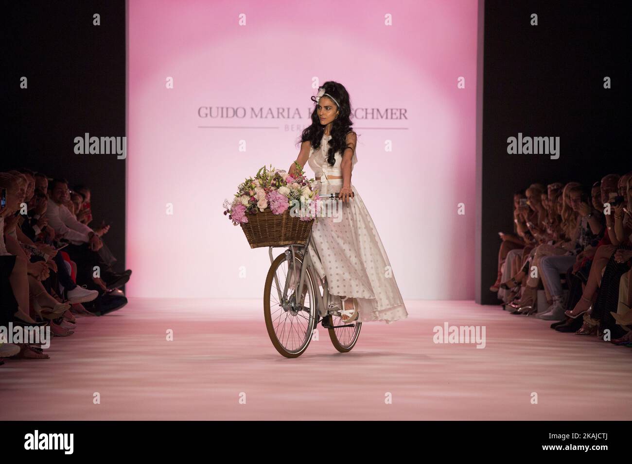A model rides the runway with a bike at the Guido Maria Kretschmer show ...