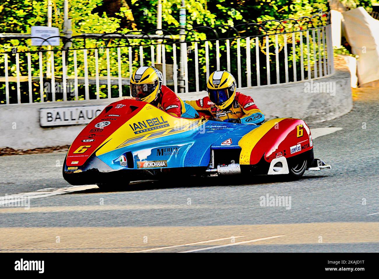 A blue, yellow and red side car with two drivers during the annual ...
