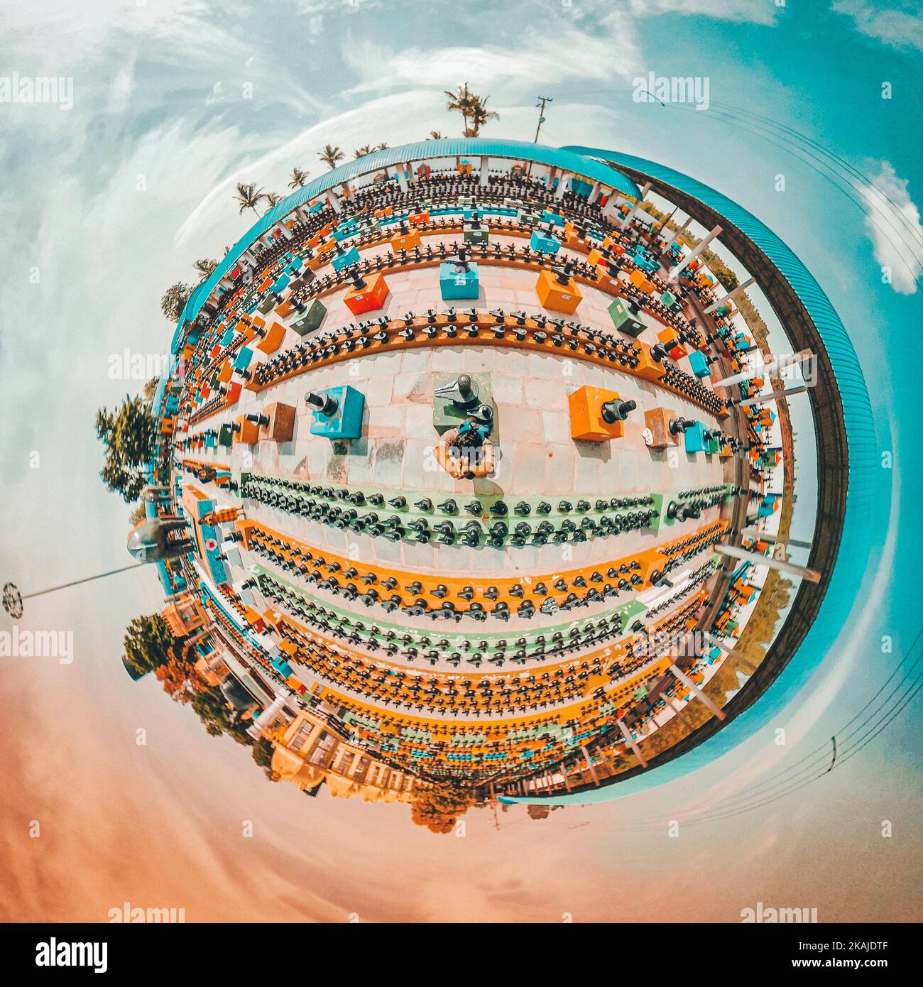 An aerial 360-degree shot of Kotilingeshwara Temple in India with palm ...