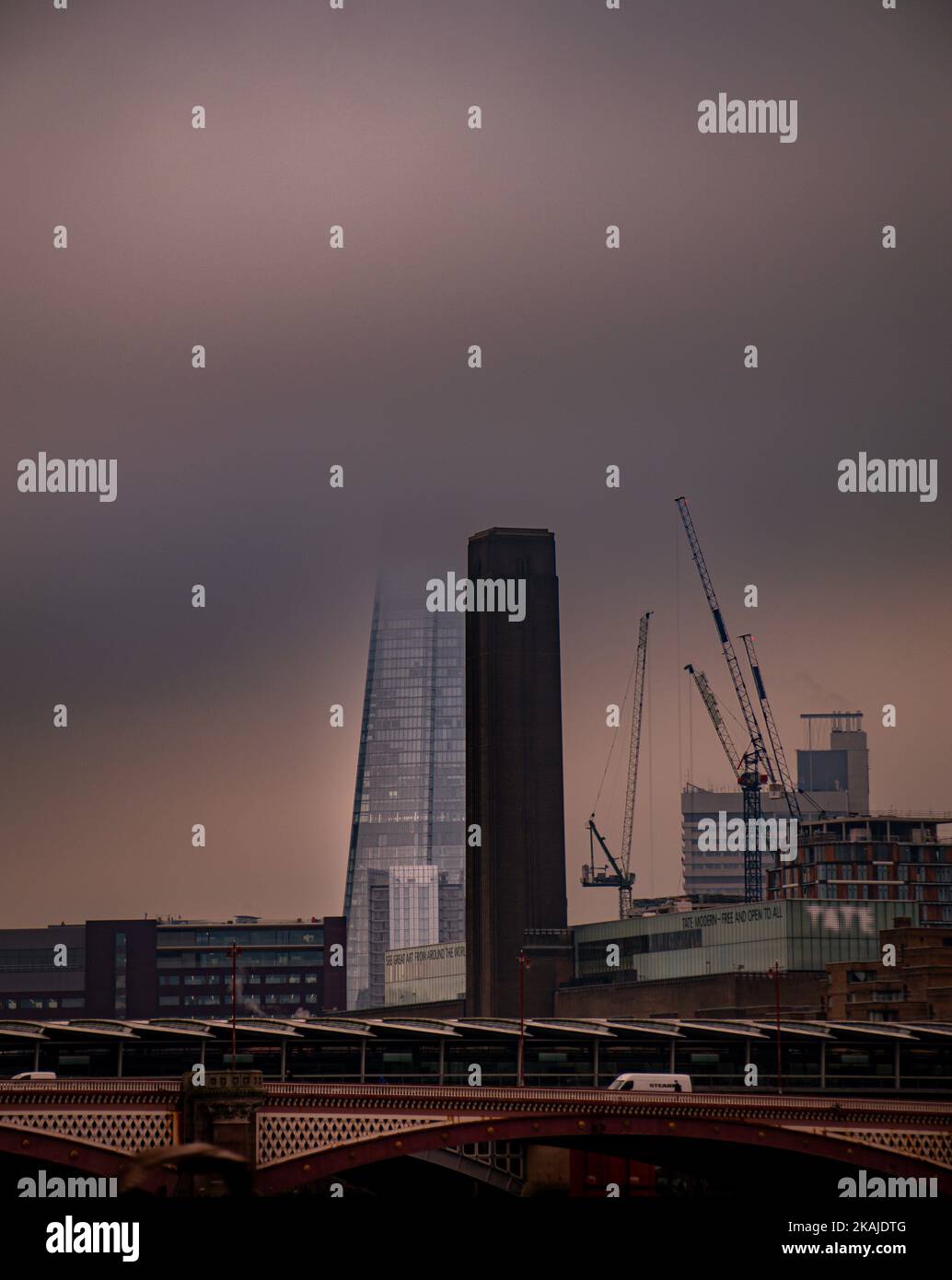 A beautiful vertical shot of the Shard disappearing into the dark low ...