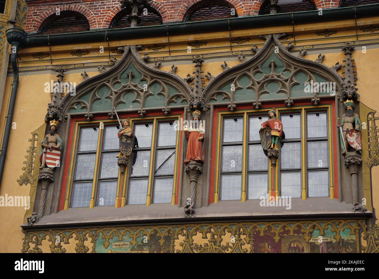 A heavily decorated wall on the Ulm Town Hall in Germany with painted ...