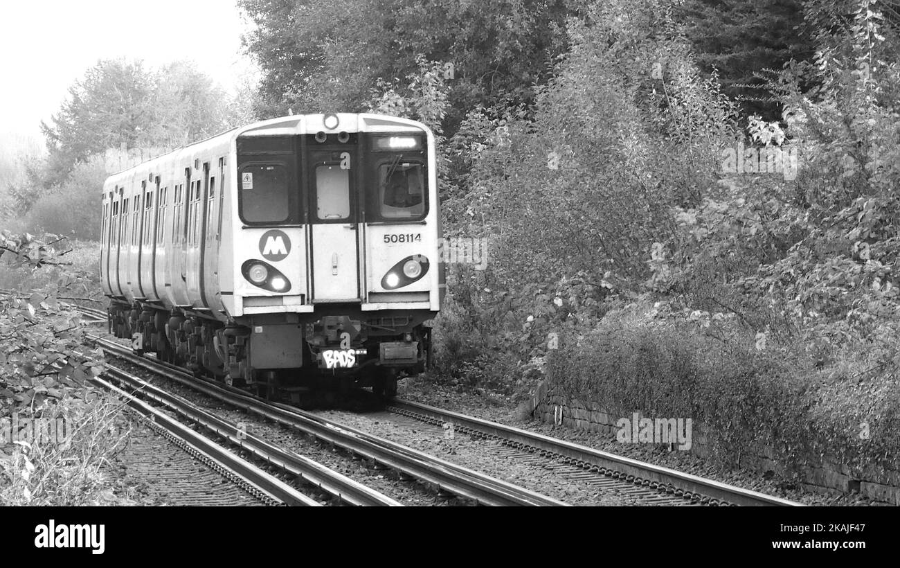 A grayscale shot of an old Merseyrail train wagon abandoned on a ...