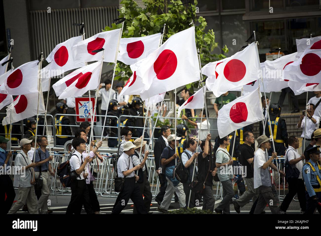 Members of nationalist group march with national flags during an anti ...