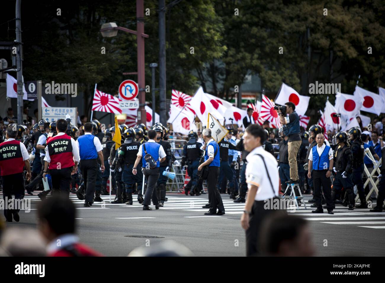 Japanese riot police guards the group of Anti-PM Shinzo Abe's members ...