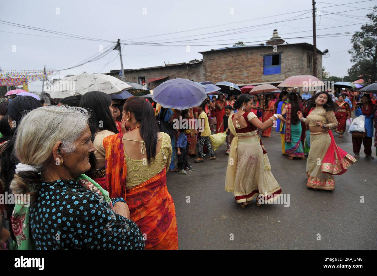 An old woman watch the dance as Hindu devotees lining to offer ritual ...