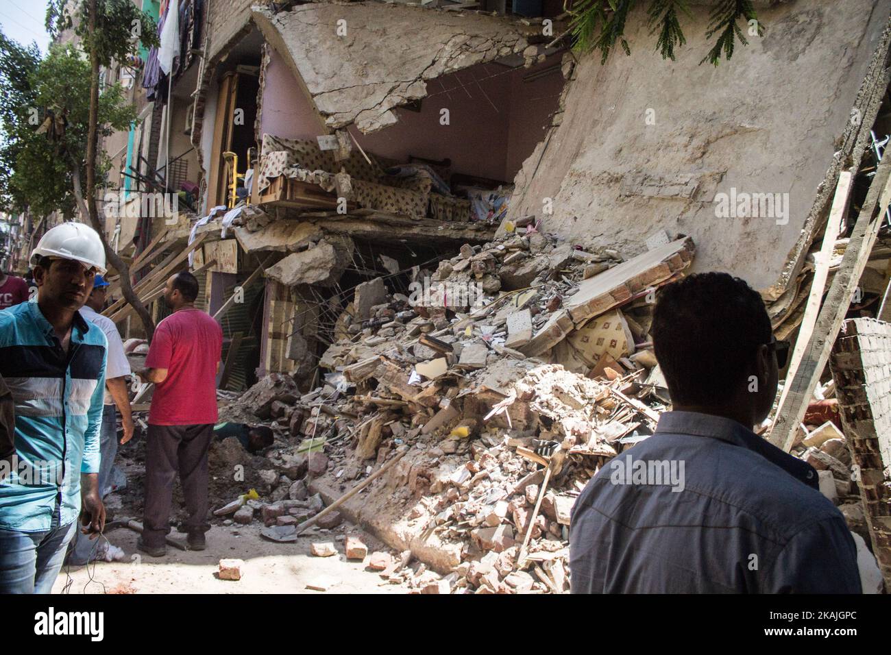 People attend the search and rescue operation for the Residential ...