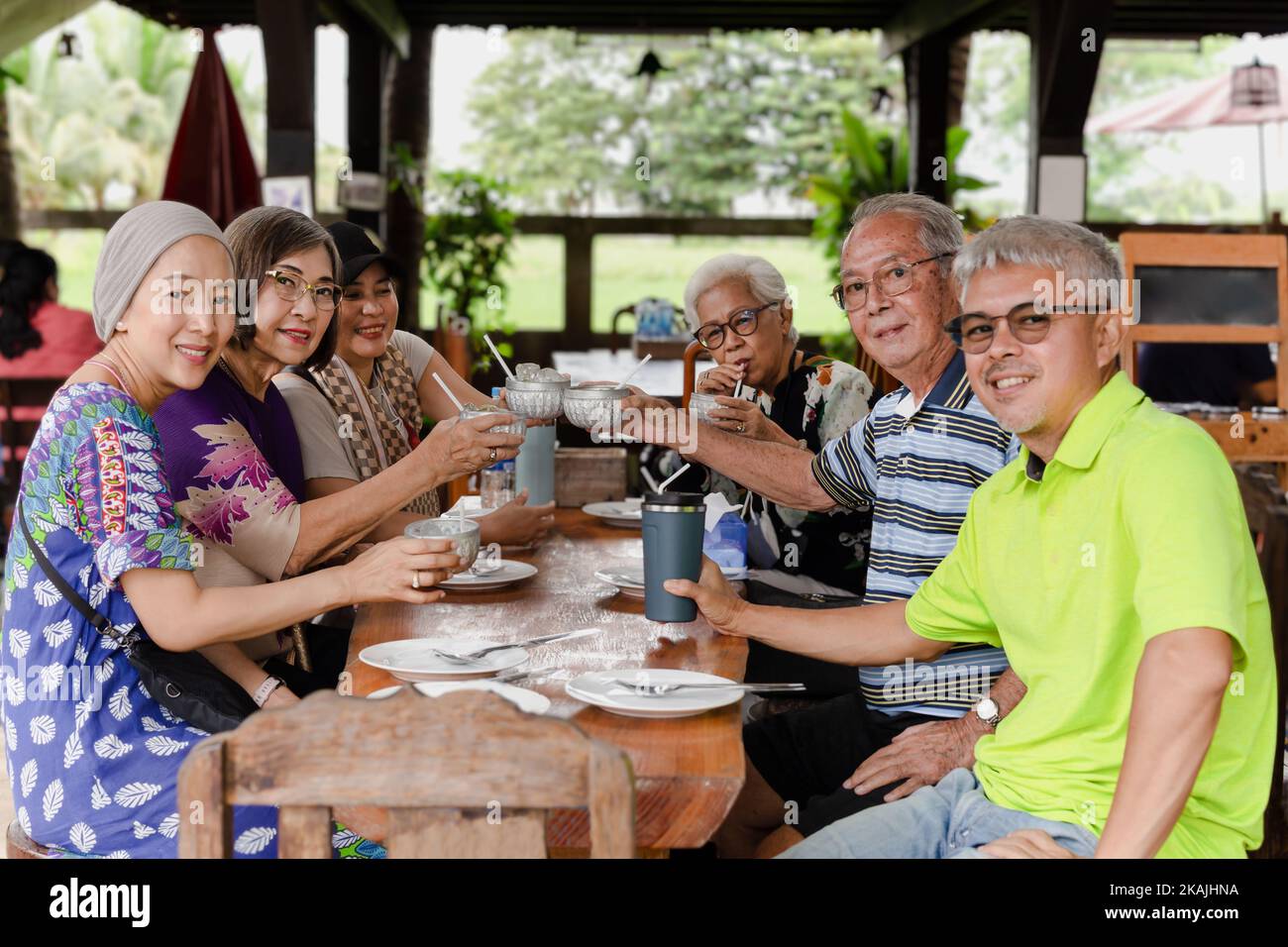 Group of happy family having lunch and making a toasting at restaurant ...
