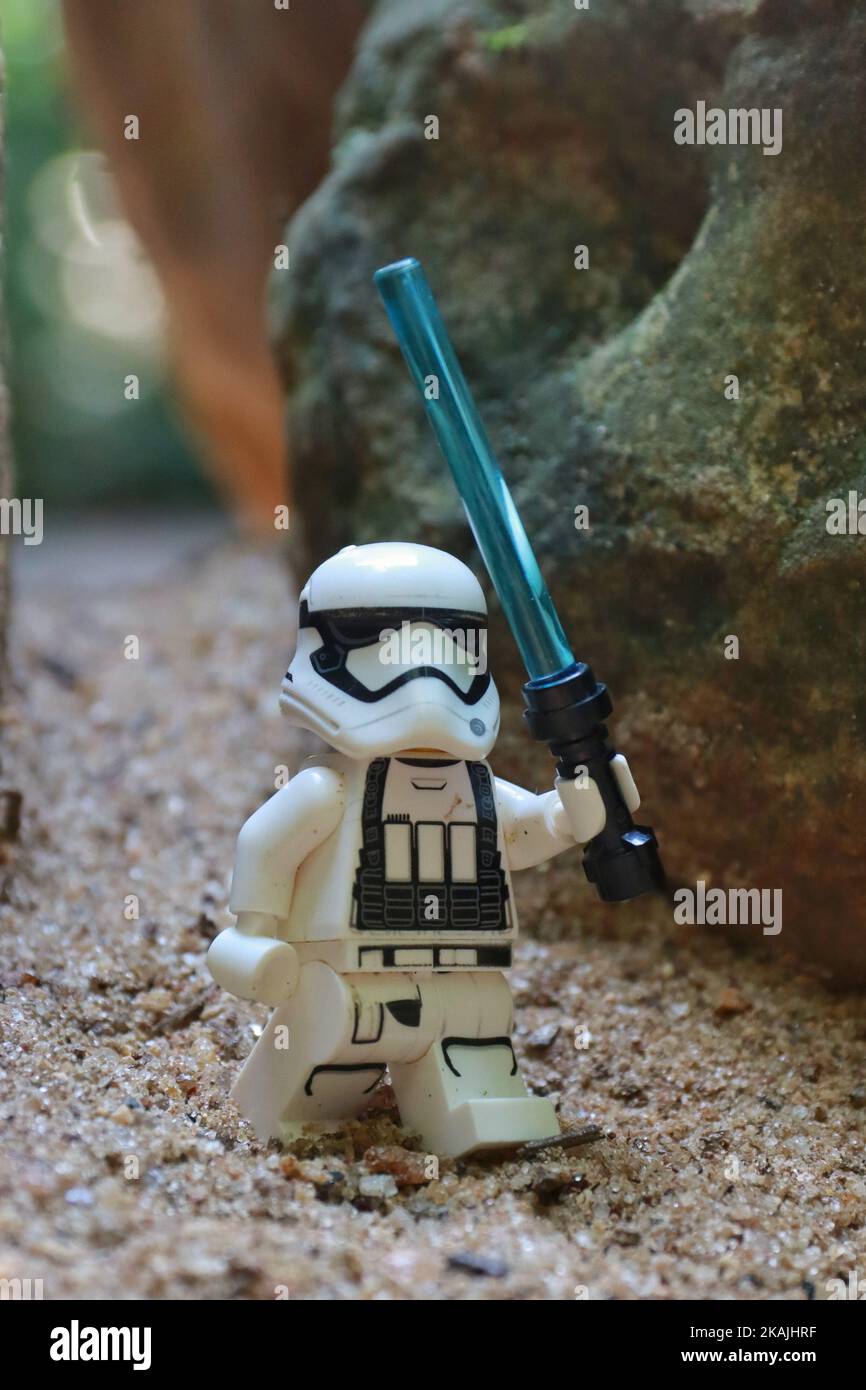 A toy trooper character wearing a helmet and carrying a saber while ...