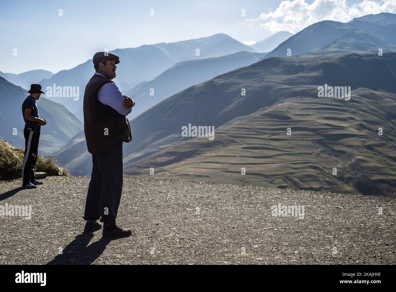 A man enjoys sunset on a street of Khinalig village, Quba region ...