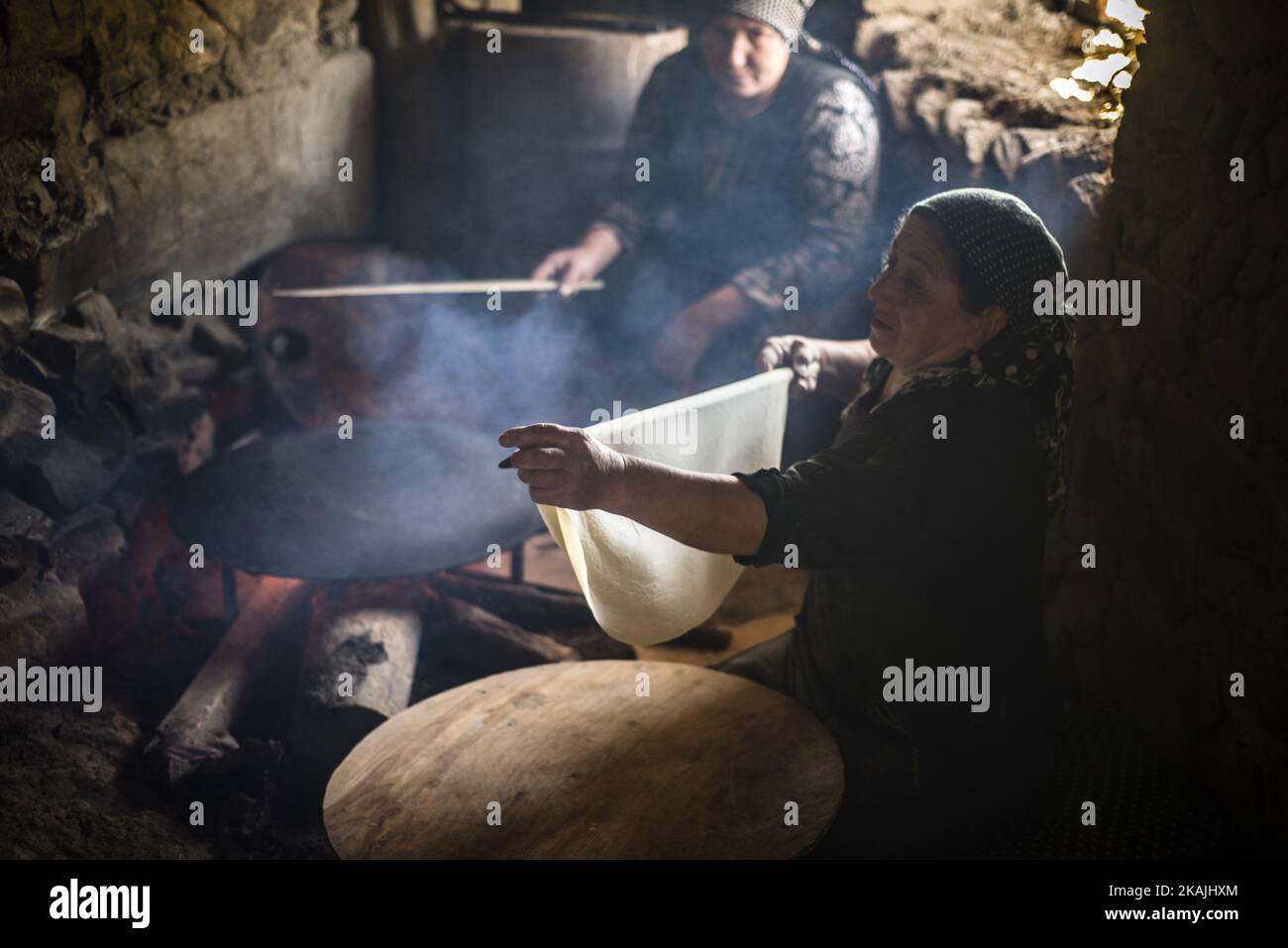 Women make bread in the kitchen of her house in Khinalig village, Quba ...