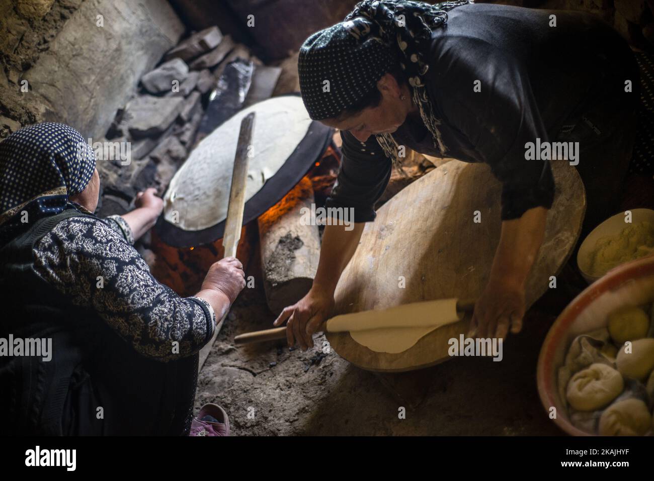 Women make bread in the kitchen of her house in Khinalig village, Quba ...