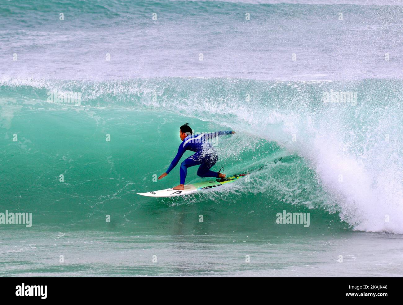 A male surfing in the ocean under a big wave Stock Photo - Alamy
