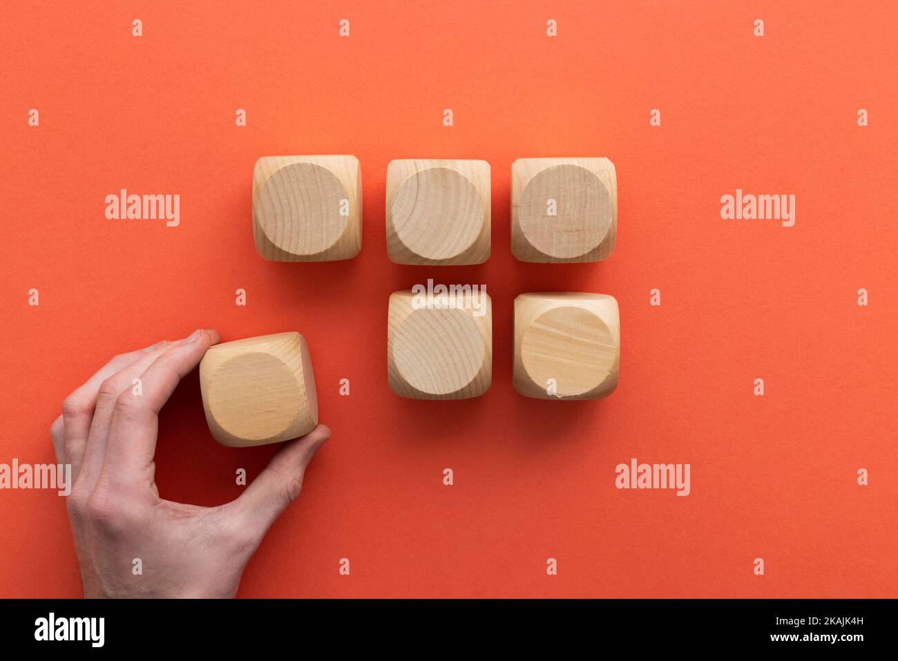 Hand choosing a wooden block from a set. Business choice concept Stock ...