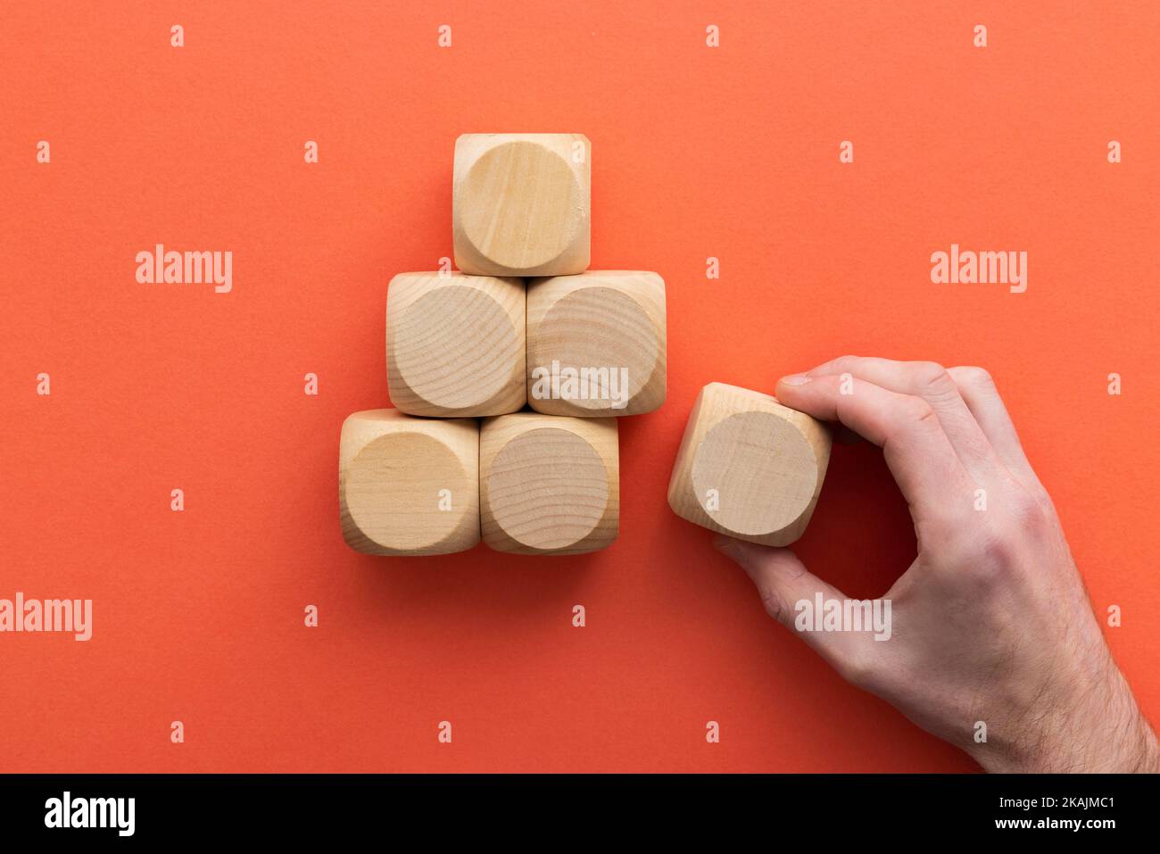 Hand choosing a wooden block from a set. Business choice concept Stock ...
