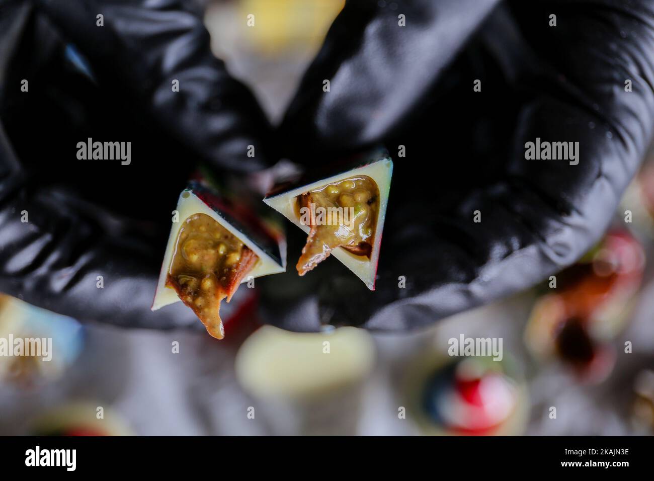 The small portions of sauces on the hand with black gloves Stock Photo ...