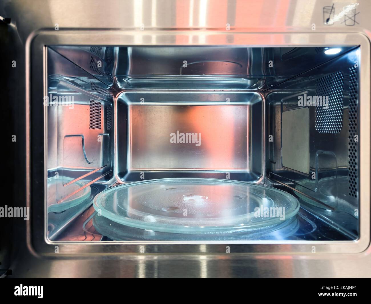 Interior of an empty modern microwave oven with glass plate inside ...