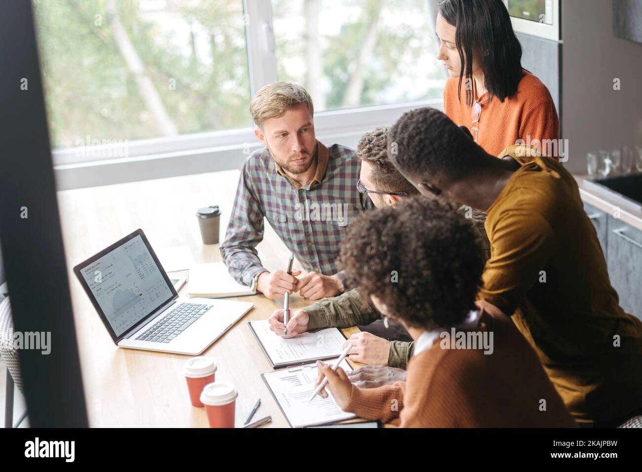 project manager is explaining something to young employees Stock Photo ...