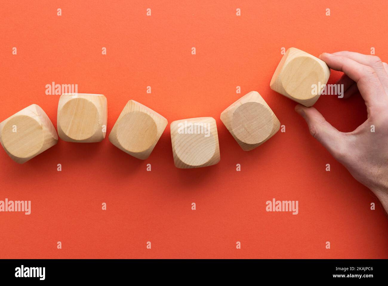Hand choosing a wooden block from a set. Business choice concept Stock ...