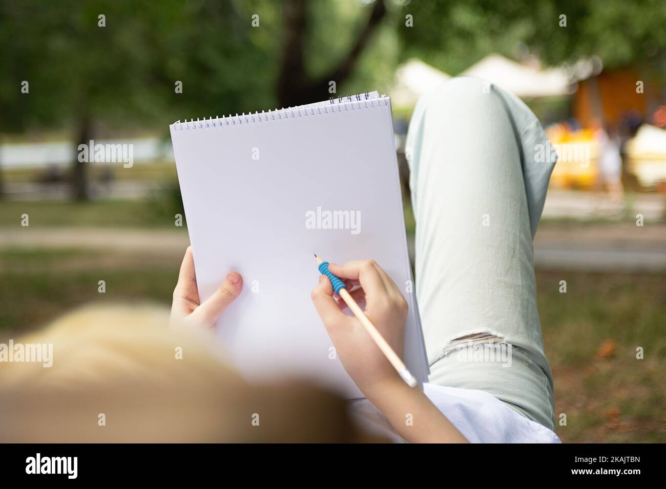 Anonymous girl making notes or drawing in the blank paper book Stock ...
