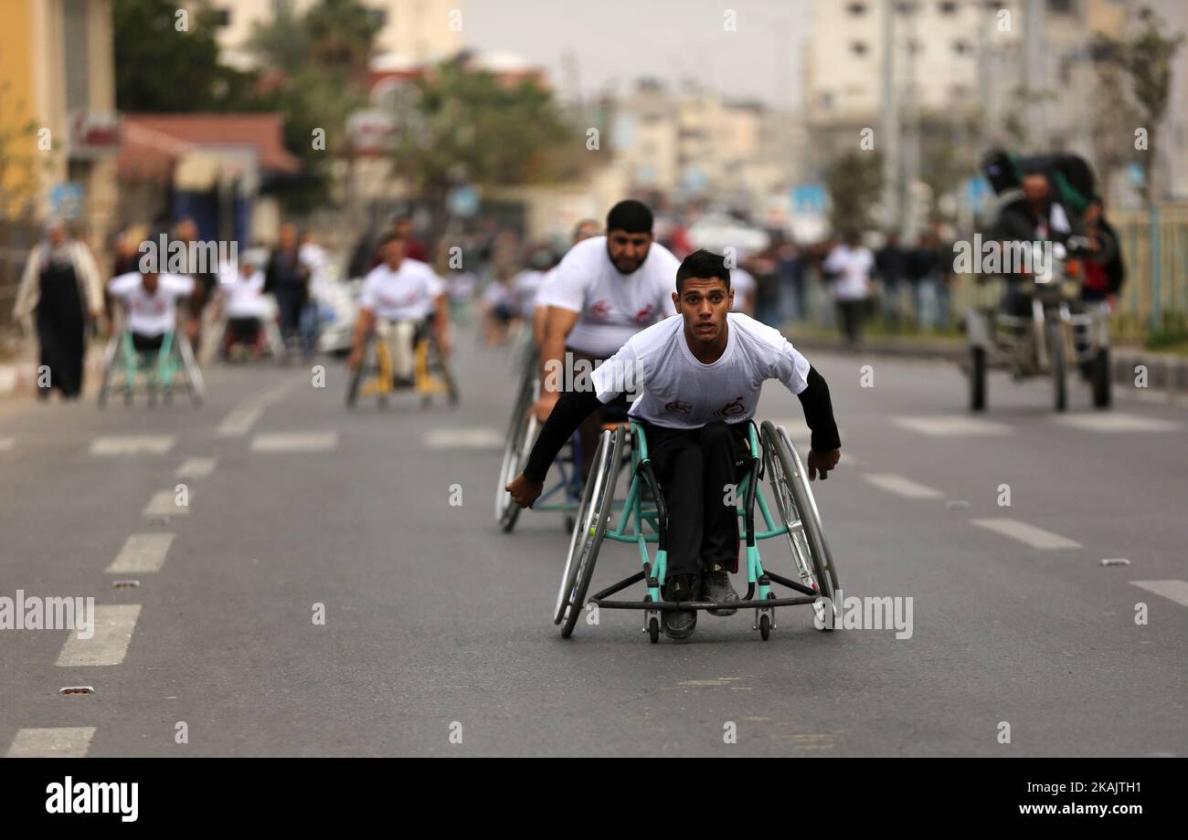 Palestinian men on their wheelchairs compete in a marathon organised ...