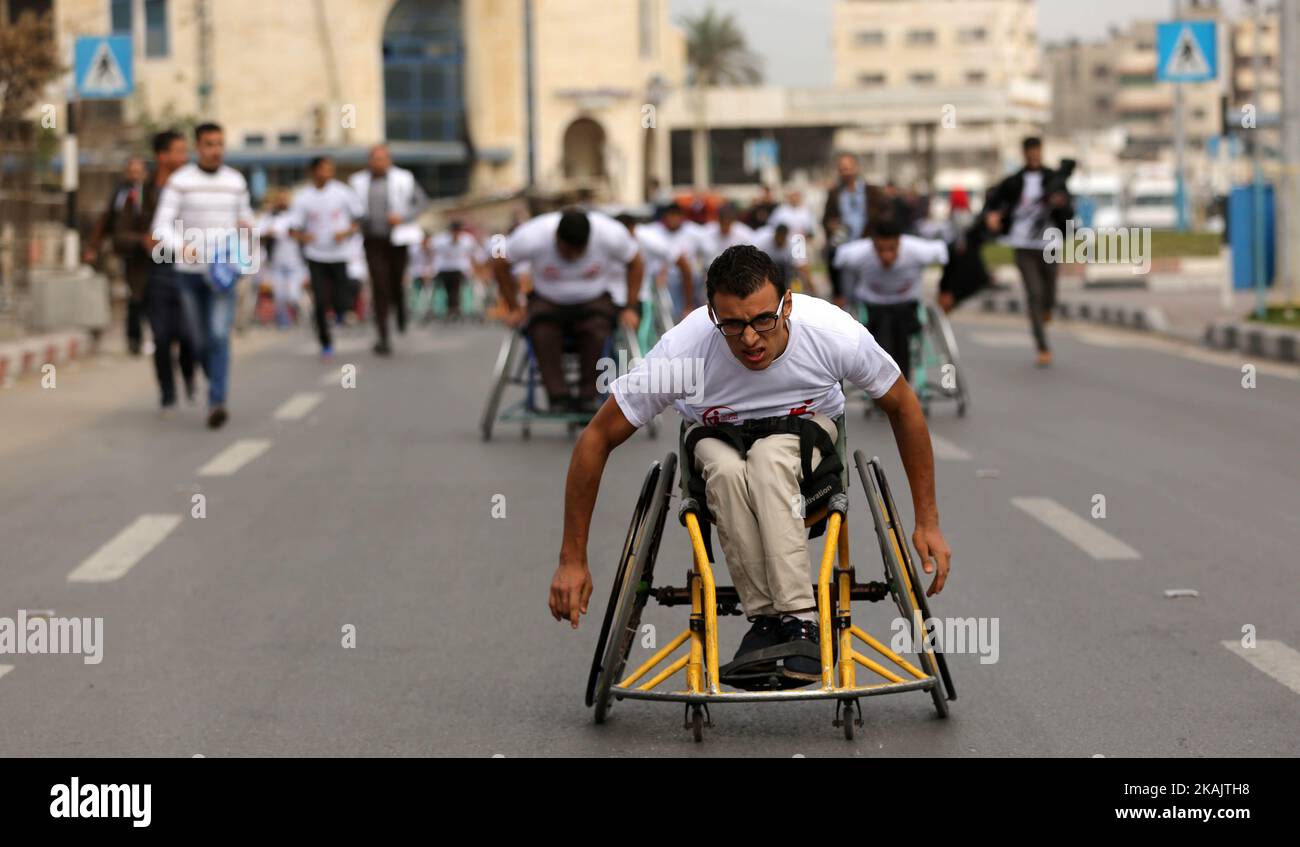 Palestinian men on their wheelchairs compete in a marathon organised ...