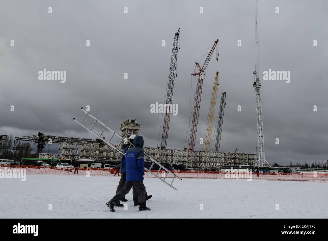 Workers of "Novarka" cross the construction site of the New Safe ...