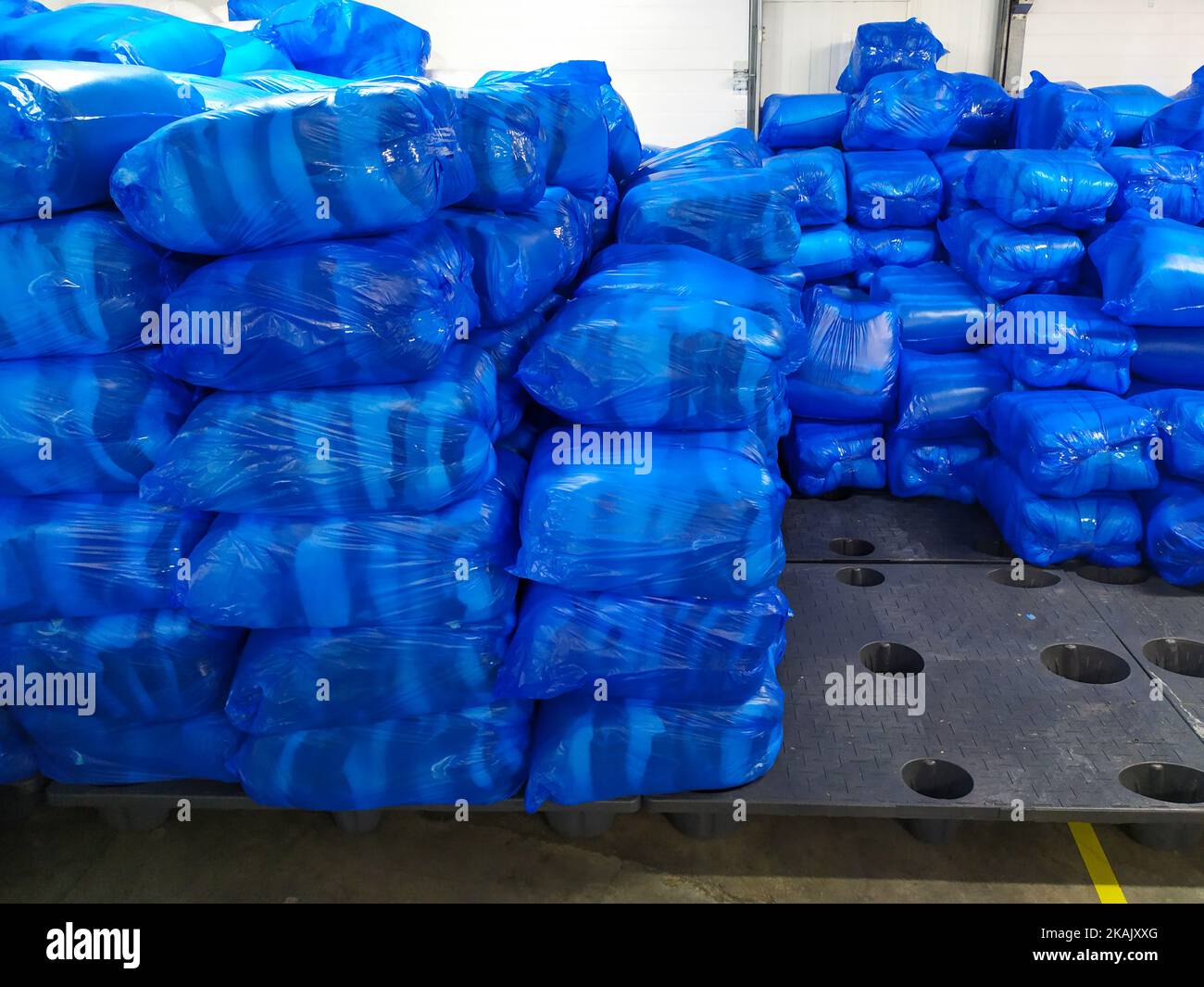 The blue laundry bags with clothes stored on pallets Stock Photo - Alamy