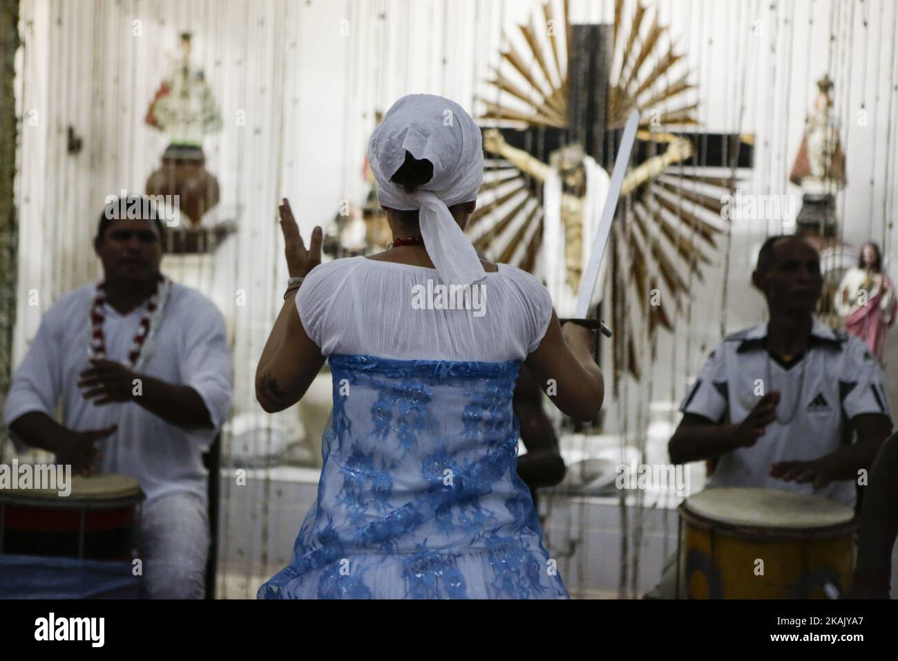 A woman, taken by a spirit, dances in trance with a plastic sword ...