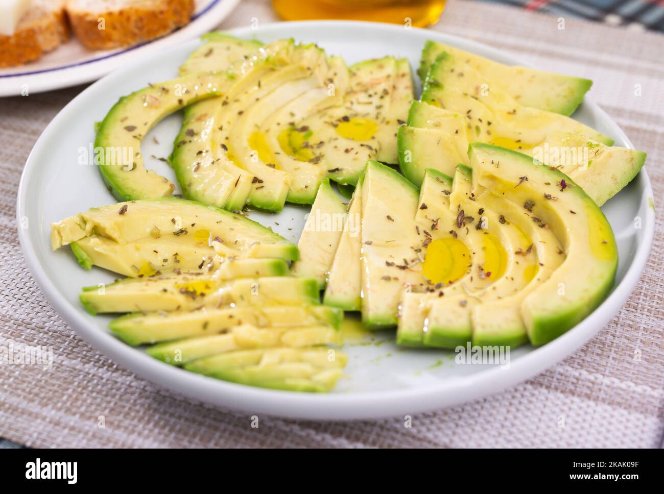 ripe avocado pulp cut into pieces sprinkled with lemon juice on a plate ...