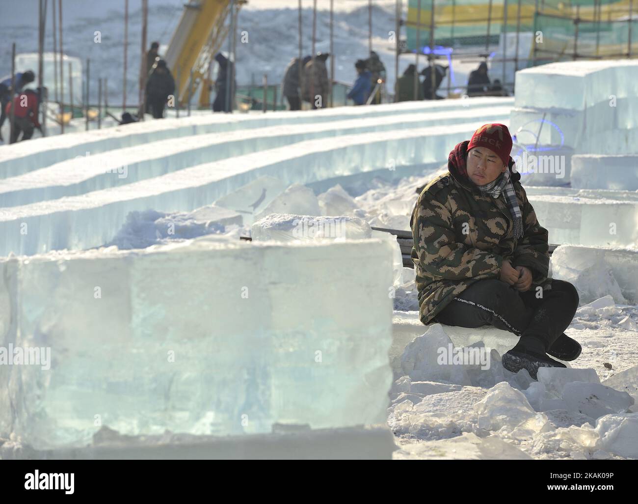People building ice sculptures of the Harbin Ice-Snow World in Harbin ...