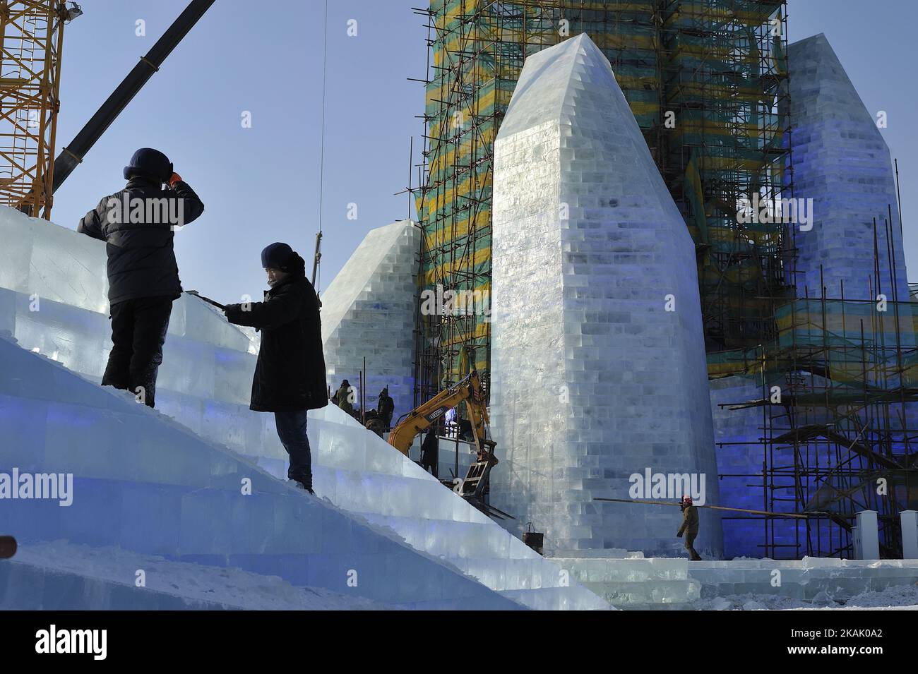 People building ice sculptures of the Harbin Ice-Snow World in Harbin ...