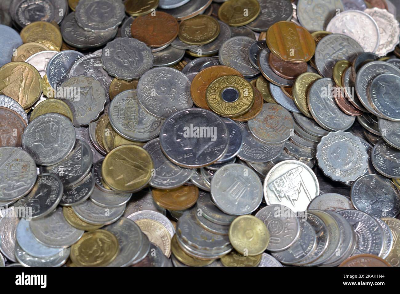 Pile of old coins of different values from different countries of the ...